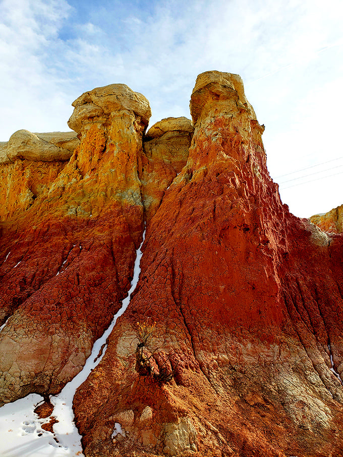These towering hoodoos stand like nature's skyscrapers, dressed in their finest rust-colored suits with cream-colored caps.