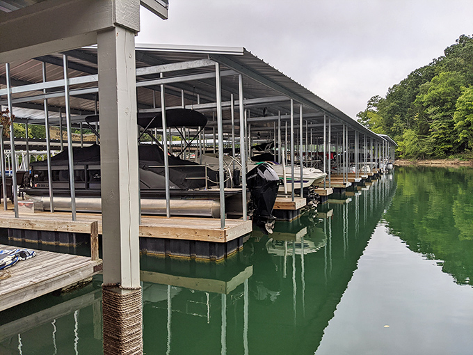 Whitman Hollow Marina's covered boat slips reflect in Norris Lake's pristine waters &ndash; retirement dreams floating on affordable real estate.