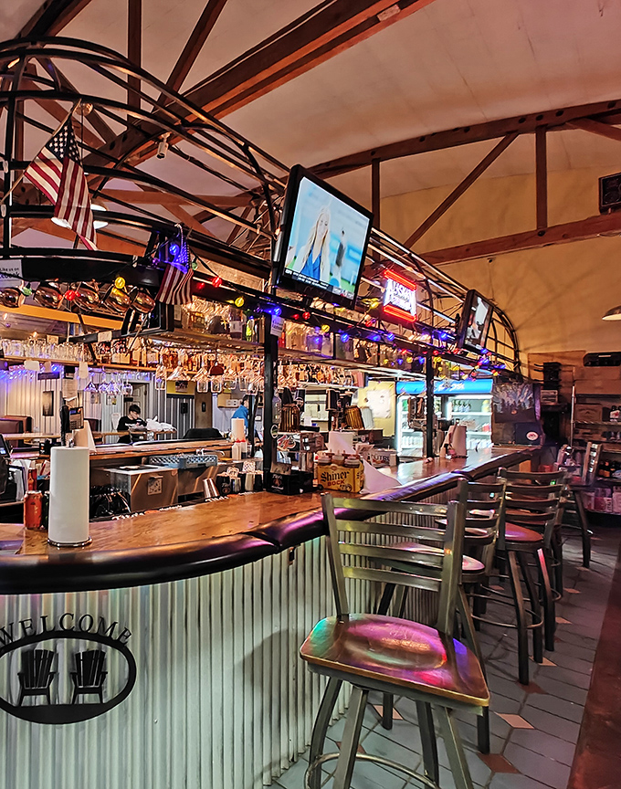 The bar area glows with neon warmth, a wood-and-metal oasis where barbecue pilgrims can wash down their religious experience with something cold.
