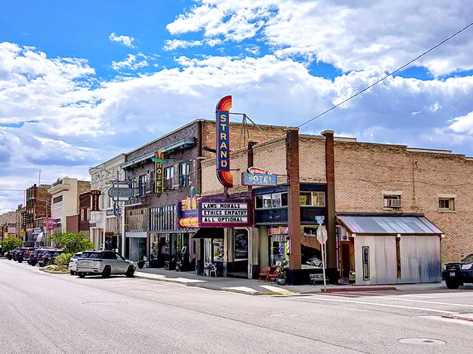 The Strand Theater's neon sign promises entertainment without big-city prices. Main Street's preserved facades tell stories that Netflix can't match.