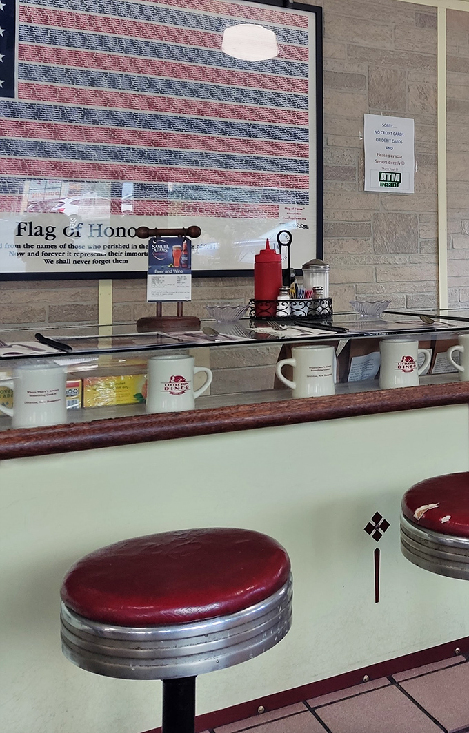 Classic counter seating with red vinyl stools where regulars gather to solve world problems over eggs and excellent coffee every single morning.