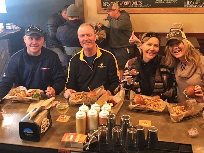 Happy diners with that unmistakable look of burger satisfaction&mdash;the universal expression that says "worth every mile of the drive."