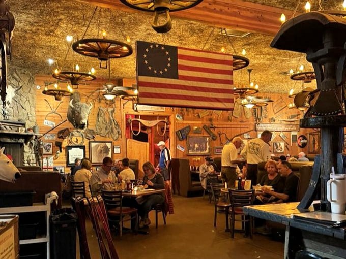 Where strangers become neighbors under wagon wheel chandeliers and vintage flags. The true spirit of the West lives in these shared meals.