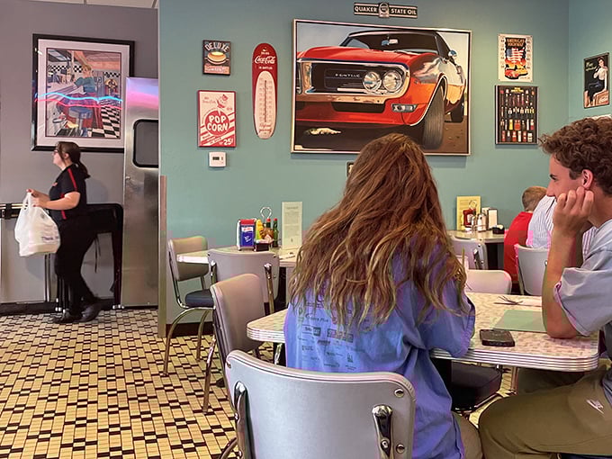 The turquoise walls and classic car artwork create the perfect backdrop for conversations that flow as easily as the coffee.