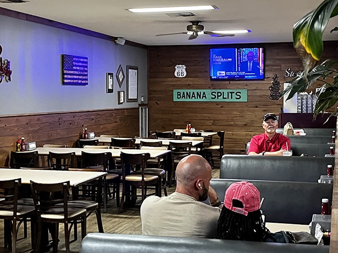 The dining area where "BANANA SPLITS" isn't just a sign&mdash;it's a promise. Route 66 memorabilia and wood paneling create the perfect small-town atmosphere.