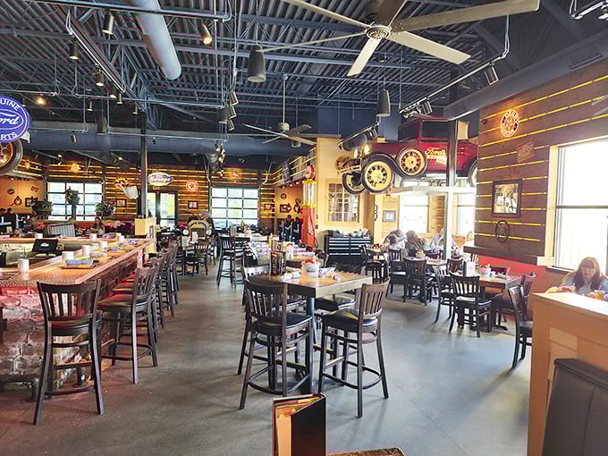 The dining area perfectly balances "garage chic" with actual comfort &ndash; those wooden chairs won't have you racing for the exit.