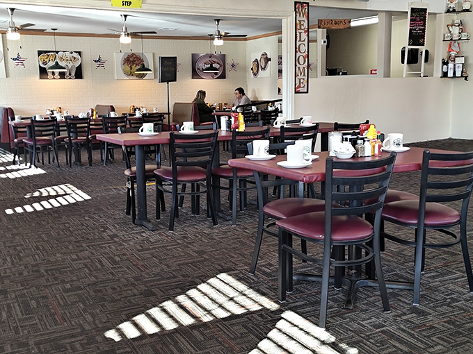 Morning light streams through windows, creating spotlight moments on empty tables that will soon host countless breakfast conversations and coffee refills.