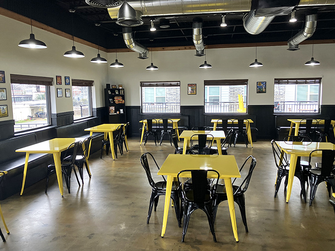 The dining area's black and yellow color scheme feels like entering a delicious warning zone: Caution – Exceptional Burgers Ahead!