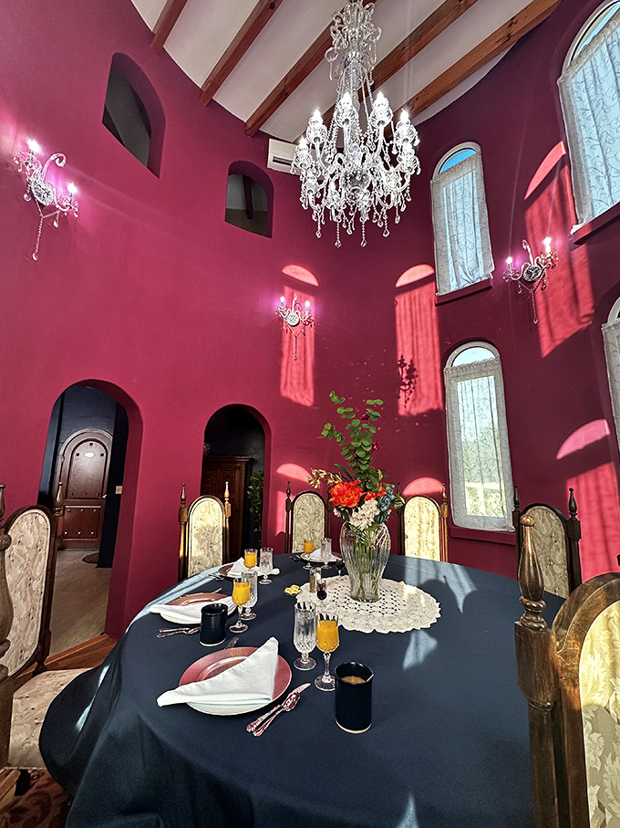 Crystal chandeliers and crimson walls set the stage for dining experiences that feel plucked from a period drama.