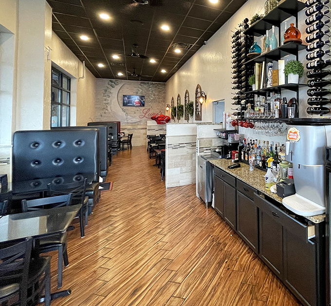 The bar area&mdash;where wine bottles stand at attention, ready to enhance your meal like supporting actors who know their craft.