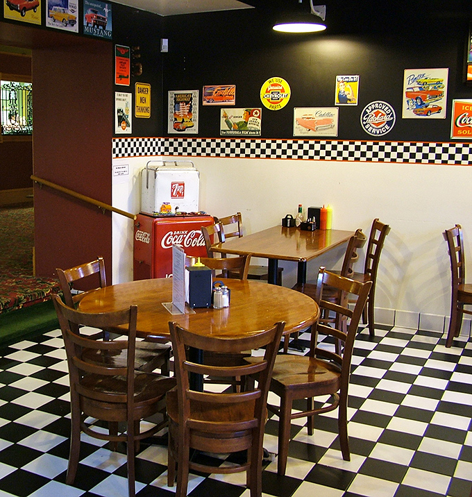 Vintage automotive memorabilia and classic diner aesthetics create an atmosphere that feels authentically nostalgic rather than manufactured retro.