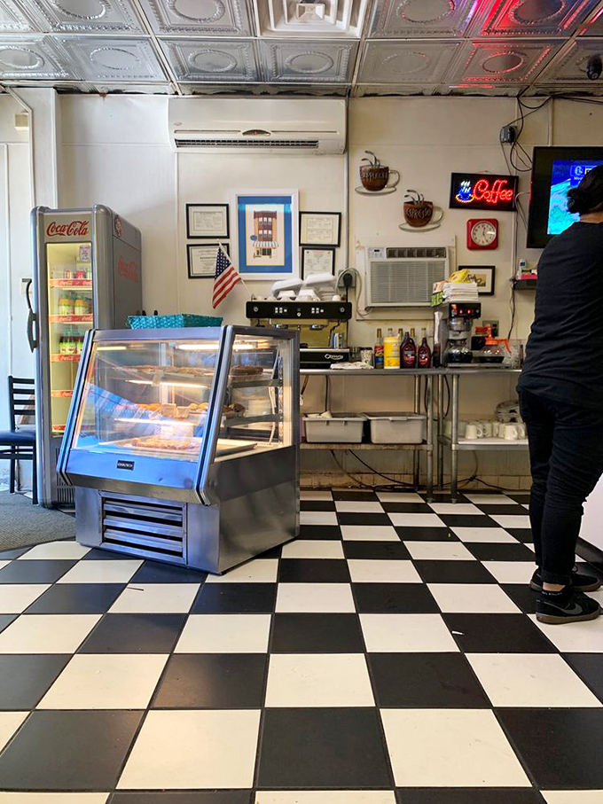 The pastry case and coffee station&mdash;breakfast's mission control center. That checkered floor leads you right to the morning essentials.