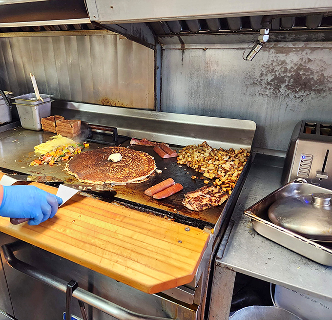 Where the magic happens: the well-seasoned griddle. Decades of flavor have seasoned this cooking surface, creating a culinary time machine with every flip.