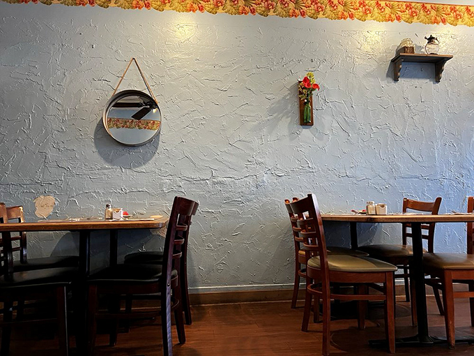 Blue walls, wooden chairs, and textured surfaces create that "you're not in a chain restaurant" atmosphere that makes every bite taste more authentic.