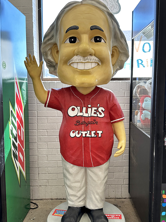 The smiling mascot statue greets shoppers like a discount store deity. His expression says, "Yes, the deals inside are exactly as good as you've heard."