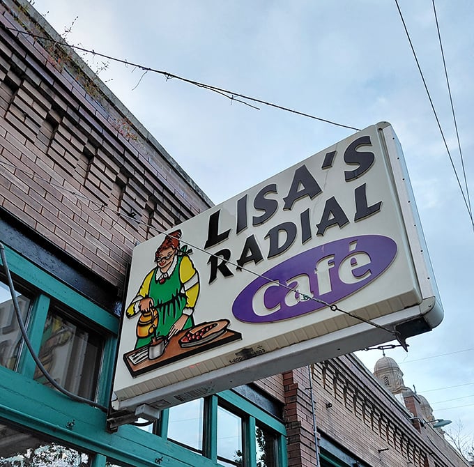 The sign promises simple pleasures inside&mdash;a cartoon chef who knows that good food doesn't need fancy explanations, just hungry customers.