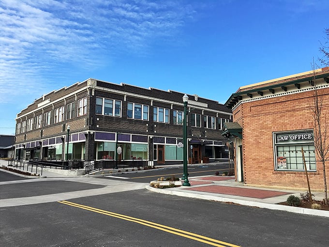 Historic brick buildings line Priest River's main street, where locals shop and visitors discover authentic small-town Idaho charm without tourist prices.