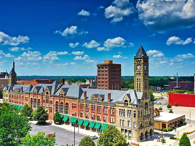 Historic downtown Springfield showcases beautiful architecture under bright blue skies, with the iconic clock tower standing proudly against puffy white clouds.