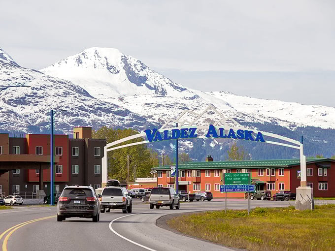 Valdez welcomes visitors with its iconic blue sign, where snow-capped peaks and colorful buildings create the perfect Alaskan postcard moment.