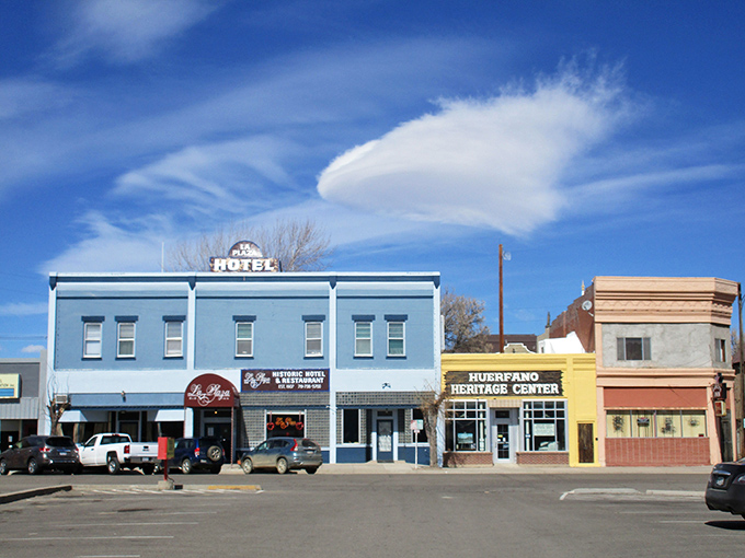 Walsenburg's historic blue building houses local businesses where neighbors meet, showcasing the town's preserved character and affordable charm.