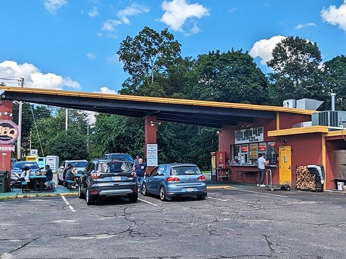Commonwealth BBQ parking lot: Cars gather like pilgrims at this simple red structure - the BBQ equivalent of "if you build it, they will come."