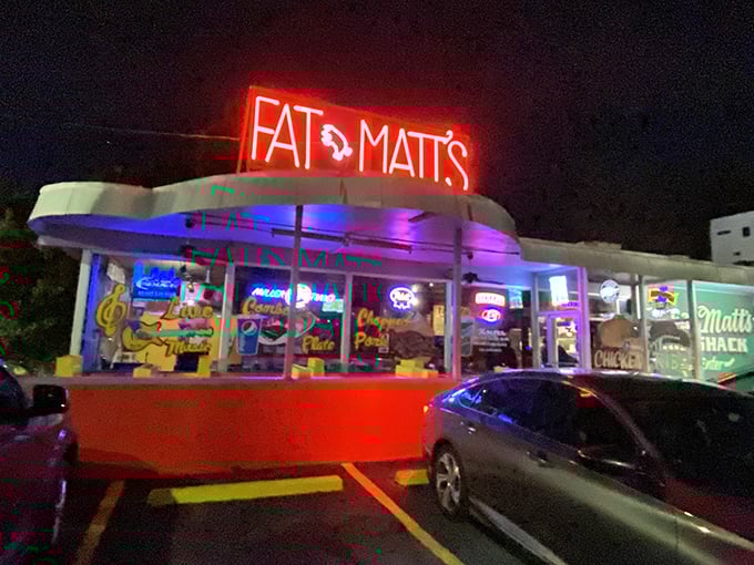 Fat Matt's neon sign glows like a barbecue lighthouse in the night. Those illuminated windows promise smoky salvation for hungry night owls.