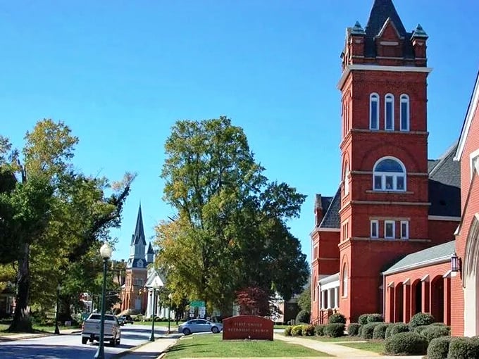 Historic church towers stand tall against a bright blue sky in charming downtown Laurens, South Carolina.