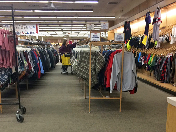 Those endless clothing racks stretch like a rainbow of secondhand possibilities for every budget-conscious shopper.