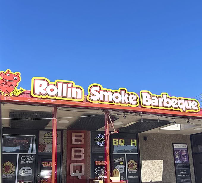 The bright Rollin Smoke sign cuts through Vegas glitz with a simple promise&mdash;serious barbecue awaits inside these doors.