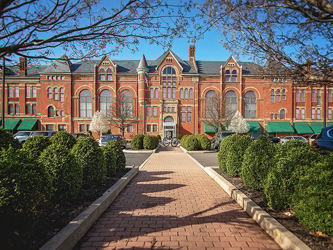Historic brick building in Springfield showcases stunning architecture with manicured pathway and green awnings.