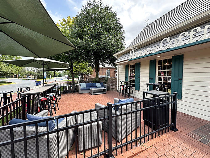 The charming exterior of House of Coffi beckons with its cream siding and brick pathway&mdash;like a coffee oasis in downtown Dover.