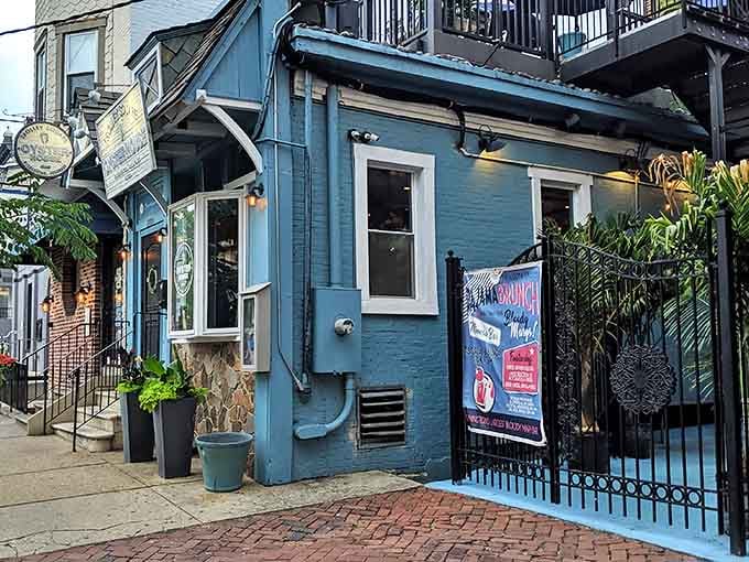 The blue facade of Trolley Square Oyster House beckons like a maritime mirage in urban Wilmington. That porthole door? Pure nautical charm.
