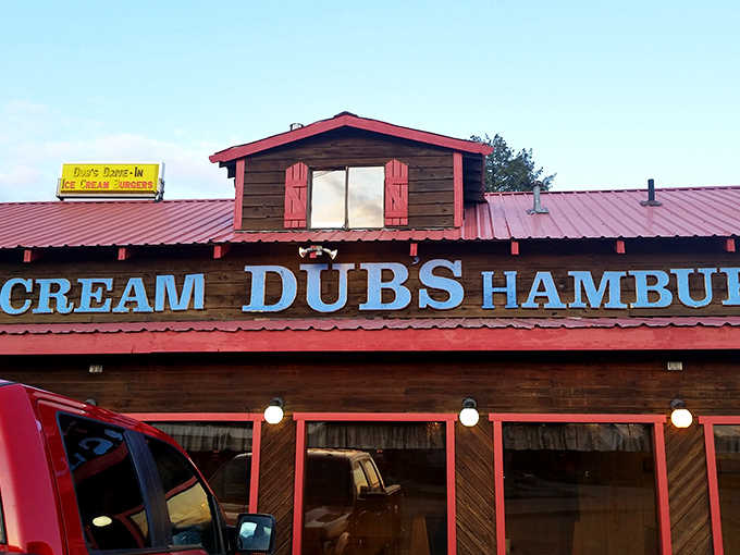 The rustic wooden exterior of Dub's Drive-In, with its signature red trim and picnic tables, stands as a time capsule of Americana in Sandpoint.
