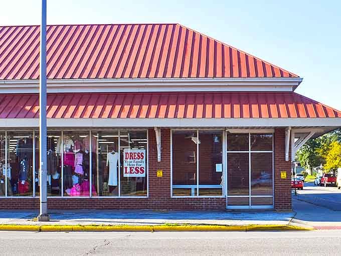 That red roof isn't just eye-catching—it's a beacon of bargain hope. The sign promising to "DRESS FOR LESS" might be the most honest advertising in retail history.