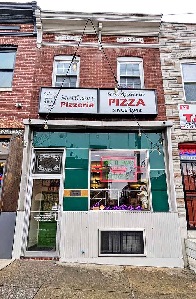 The emerald-tiled facade of Matthew's Pizzeria stands as a beacon of pizza perfection on Eastern Avenue, promising delicious traditions since 1943.