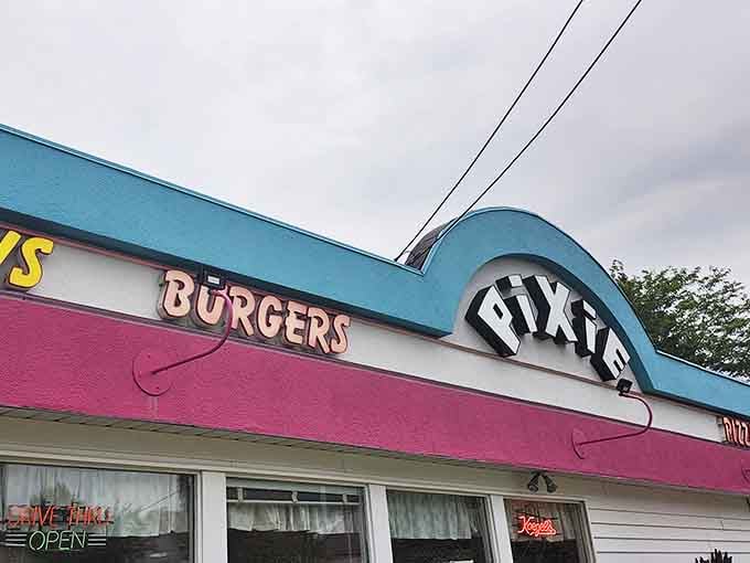The iconic teal and pink facade of the Pixie Restaurant stands as a colorful beacon of burger bliss in Mt. Pleasant, Michigan.