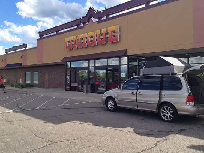 The unassuming exterior of Unique Thrift Store in Burnsville welcomes bargain hunters with its bright yellow signage and promise of treasures within.