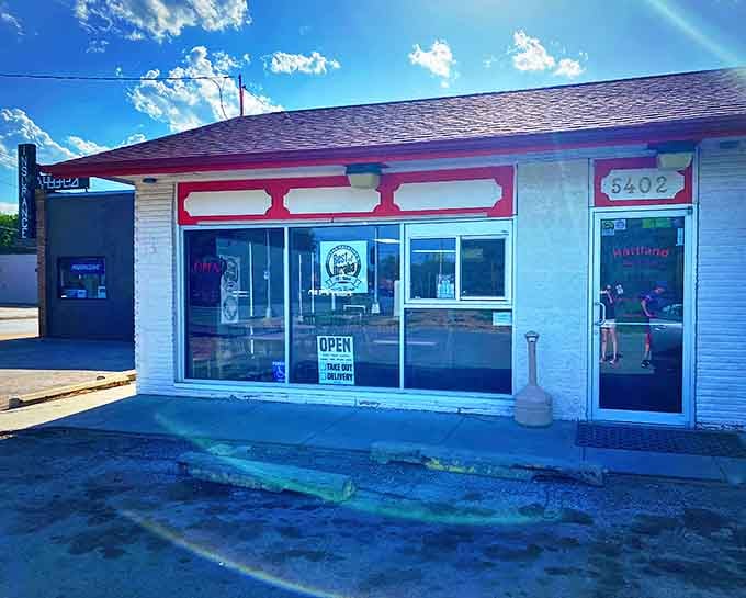 That iconic red roof signals barbecue salvation ahead. Hartland's modest exterior hides smoky treasures that have kept Omaha coming back for generations.