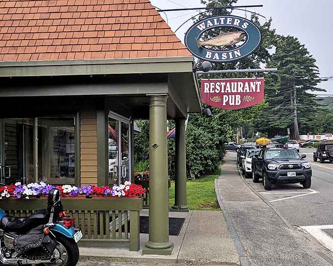 The iconic Walter's Basin sign welcomes hungry travelers, with colorful flower boxes adding a touch of New England charm to this lakeside gem.