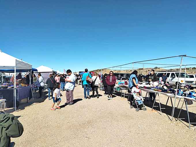 Treasure hunters navigate the dusty pathways between colorful canopies, where one person's castoffs become another's prized discoveries.