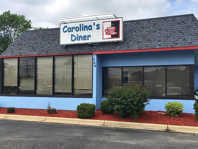 The blue and white exterior of Carolina's Diner stands as a beacon of hope for hungry travelers &ndash; a promise of honest food without pretension.