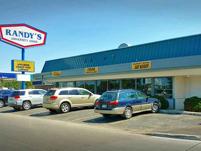 The iconic sign beckons hungry travelers like a lighthouse for the breakfast-obsessed. Those yellow banners promise specials worth investigating!