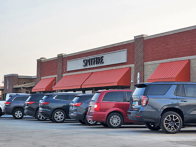 The bustling parking lot tells the story – locals know where to find the good stuff. Those distinctive red awnings signal smoky treasures await inside.