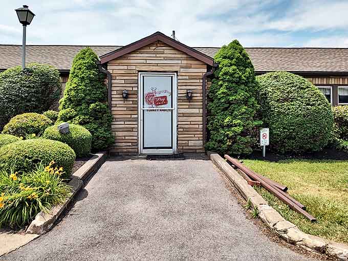The unassuming entrance to Fry Bros Turkey Ranch welcomes you like a friend's home, complete with manicured shrubs and that iconic turkey logo promising comfort ahead.