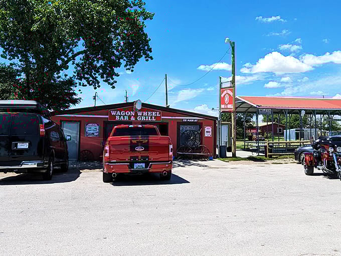 The bright red exterior of Wagon Wheel Bar & Grill stands as a beacon of hope for hungry travelers, complete with authentic wagon wheels that aren't just for show.