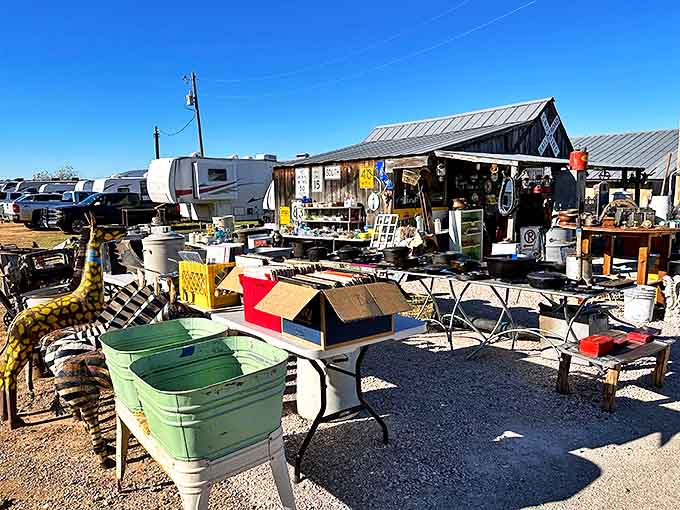 Outside this unassuming metal barn lies a treasure hunter's paradise where vintage wagons and garden art create the perfect Texas welcome committee.
