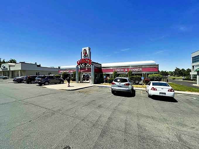 The classic '50s diner silhouette of Virg's stands proudly against Utah's blue sky, its red neon sign a beacon for hungry travelers seeking comfort food salvation.