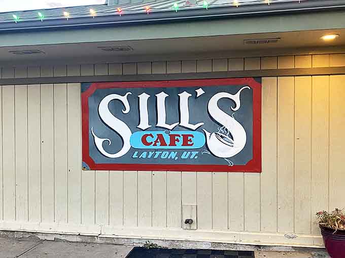 The iconic Sill's Cafe sign adorned with festive lights, beckoning hungry patrons to this beloved Layton institution.