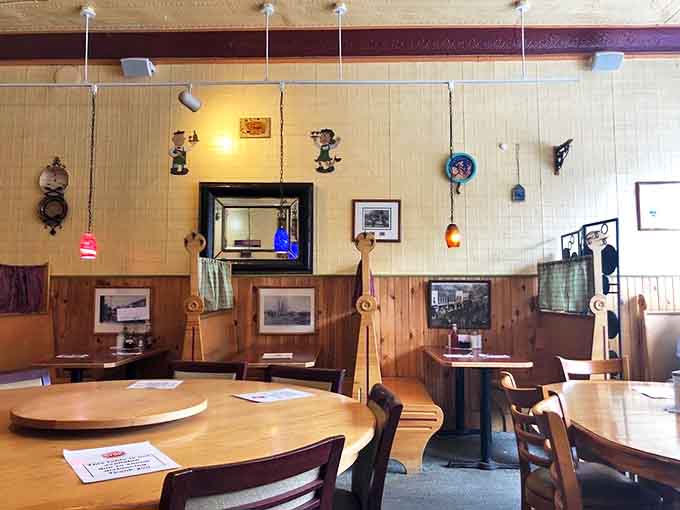 Warm wood paneling and eclectic decor create Snap's cozy atmosphere, where colorful pendant lights hang above sturdy tables ready for hearty meals.