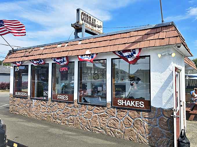 Patriotic bunting frames the promise of "BURGERS, FRIES, SHAKES" &ndash; the American food trinity that's been bringing joy to road-trippers since cars had tailfins and milkshakes cost a quarter.